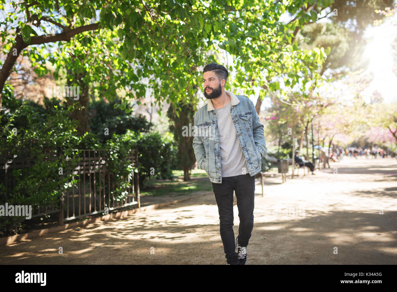 A photo of young, handsome man taking a walk at the park Stock Photo ...