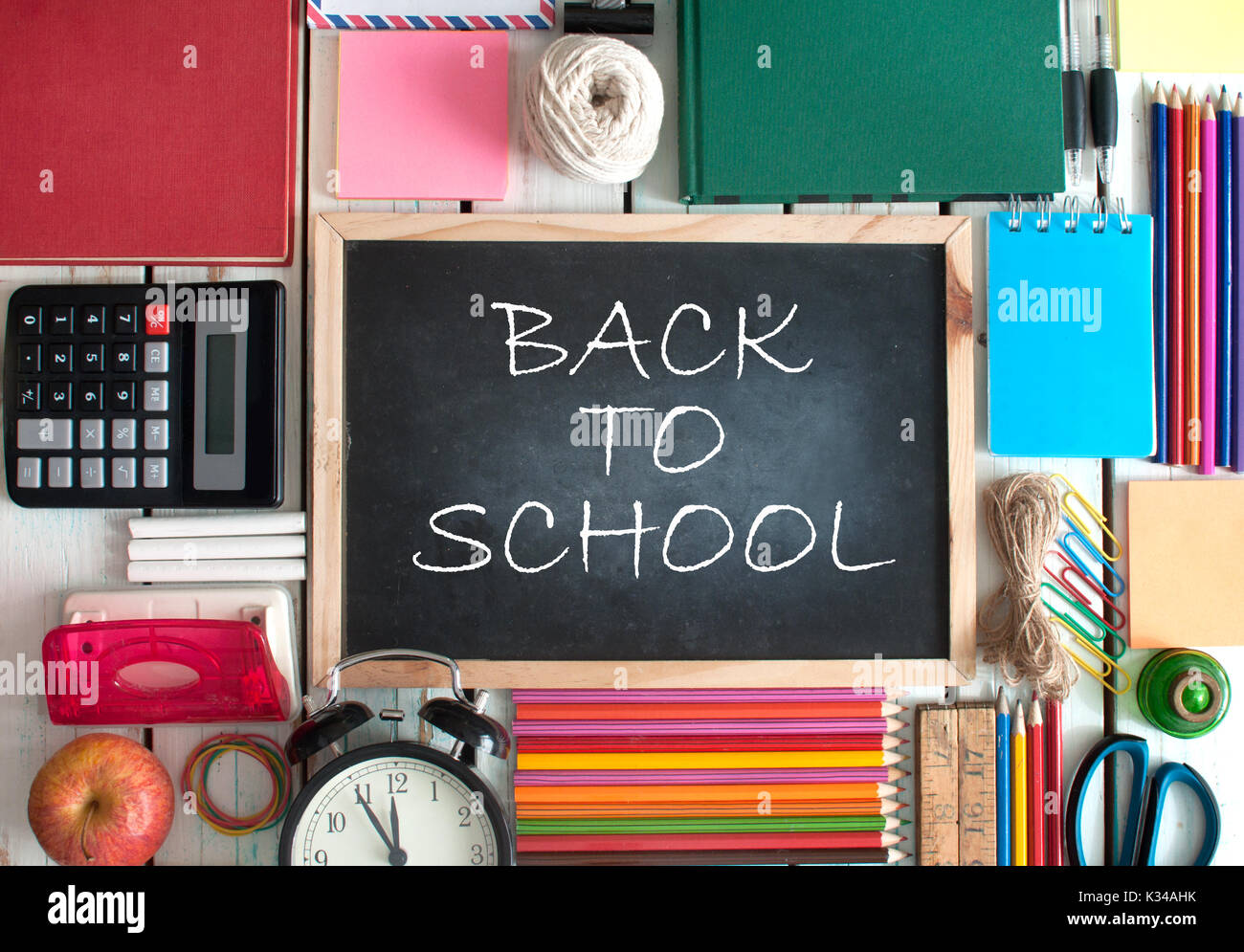 Aerial view of stationery objects with back to school on blackboard ...