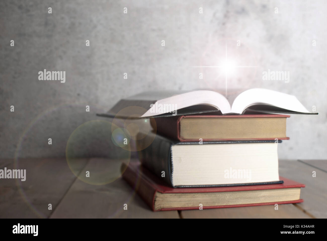Open book on top of a stack with background space Stock Photo - Alamy