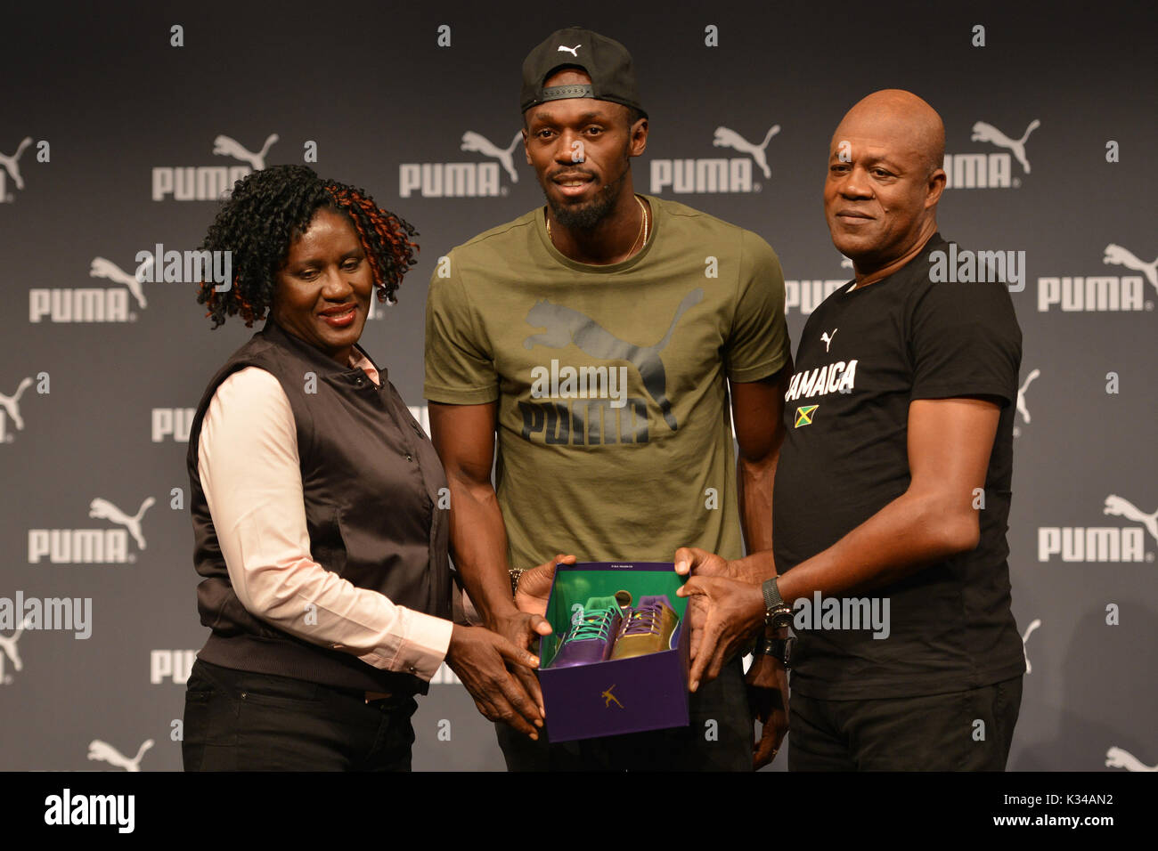 Usain Bolt’s parents present Usain with presentation shoes at a press ...