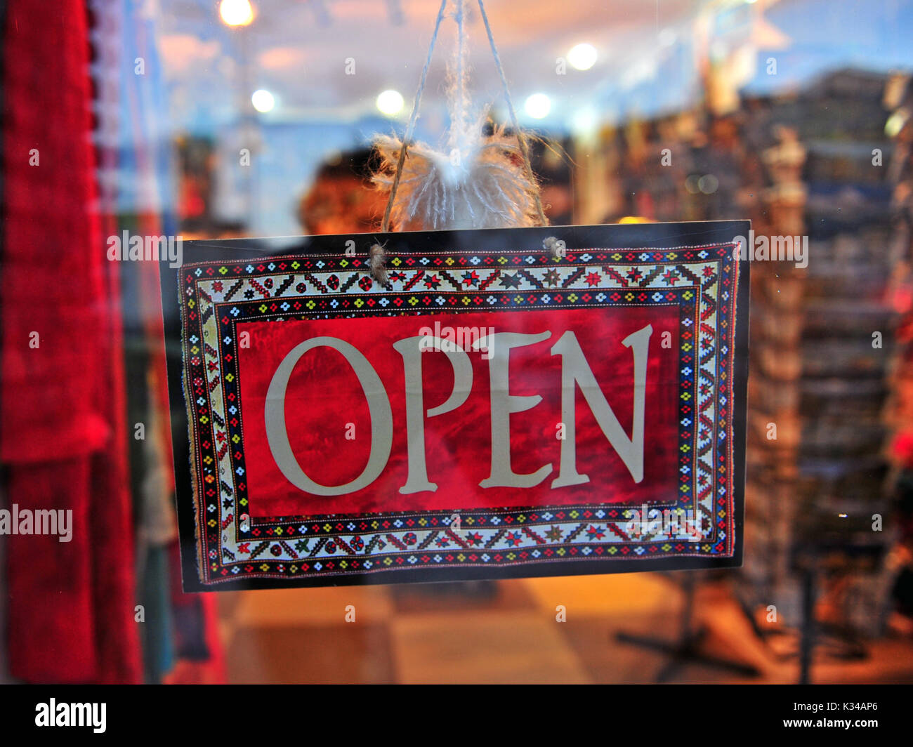 The hanging open sign in the street shop Stock Photo - Alamy