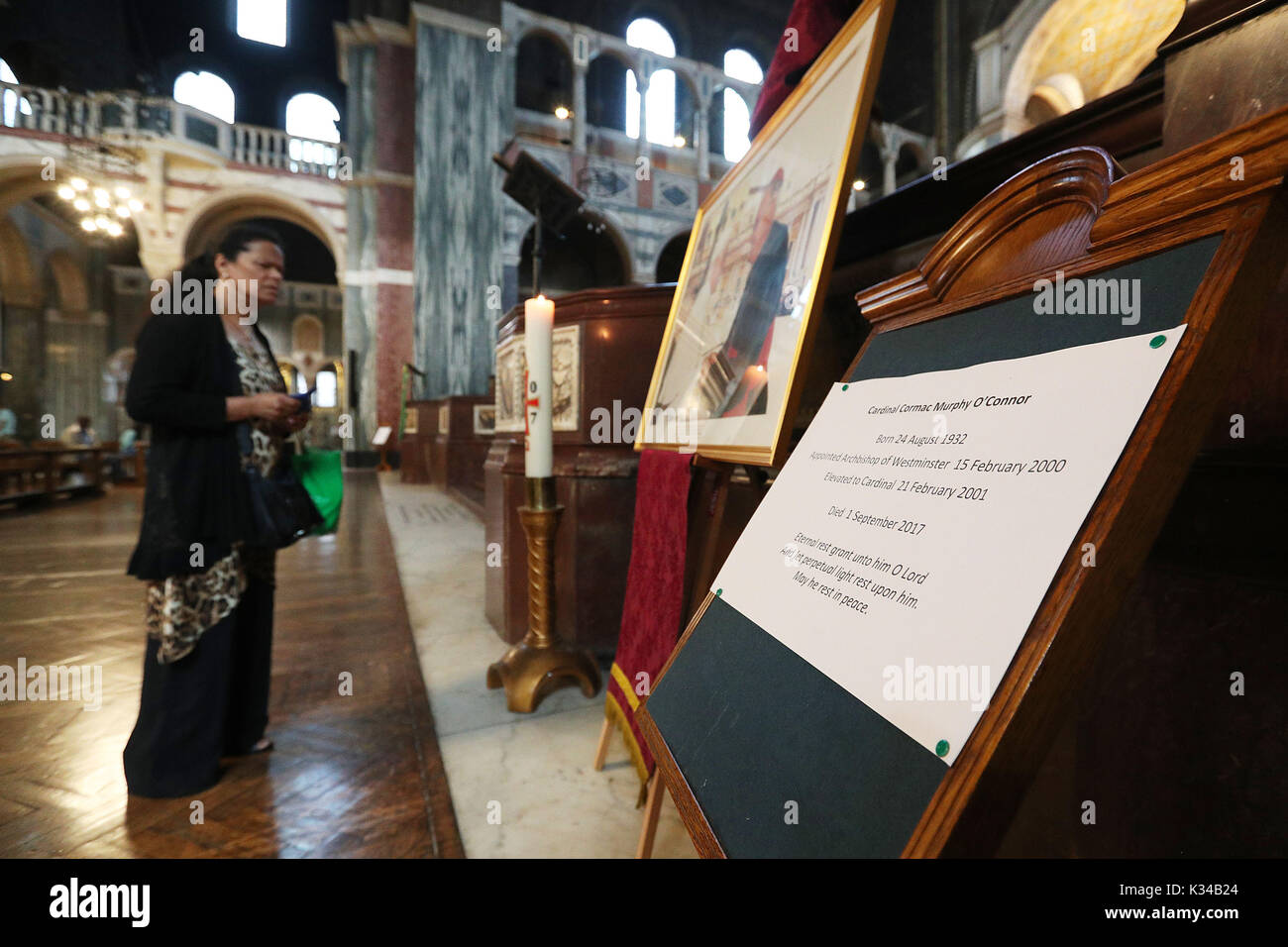 A visitor to Westminster Cathedral looks at a photo of Cardinal Cormac ...