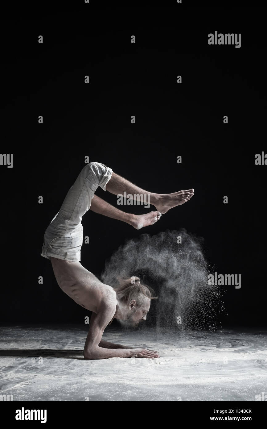 Flexible yoga man doing hand balance asana vrischikasana Stock Photo ...