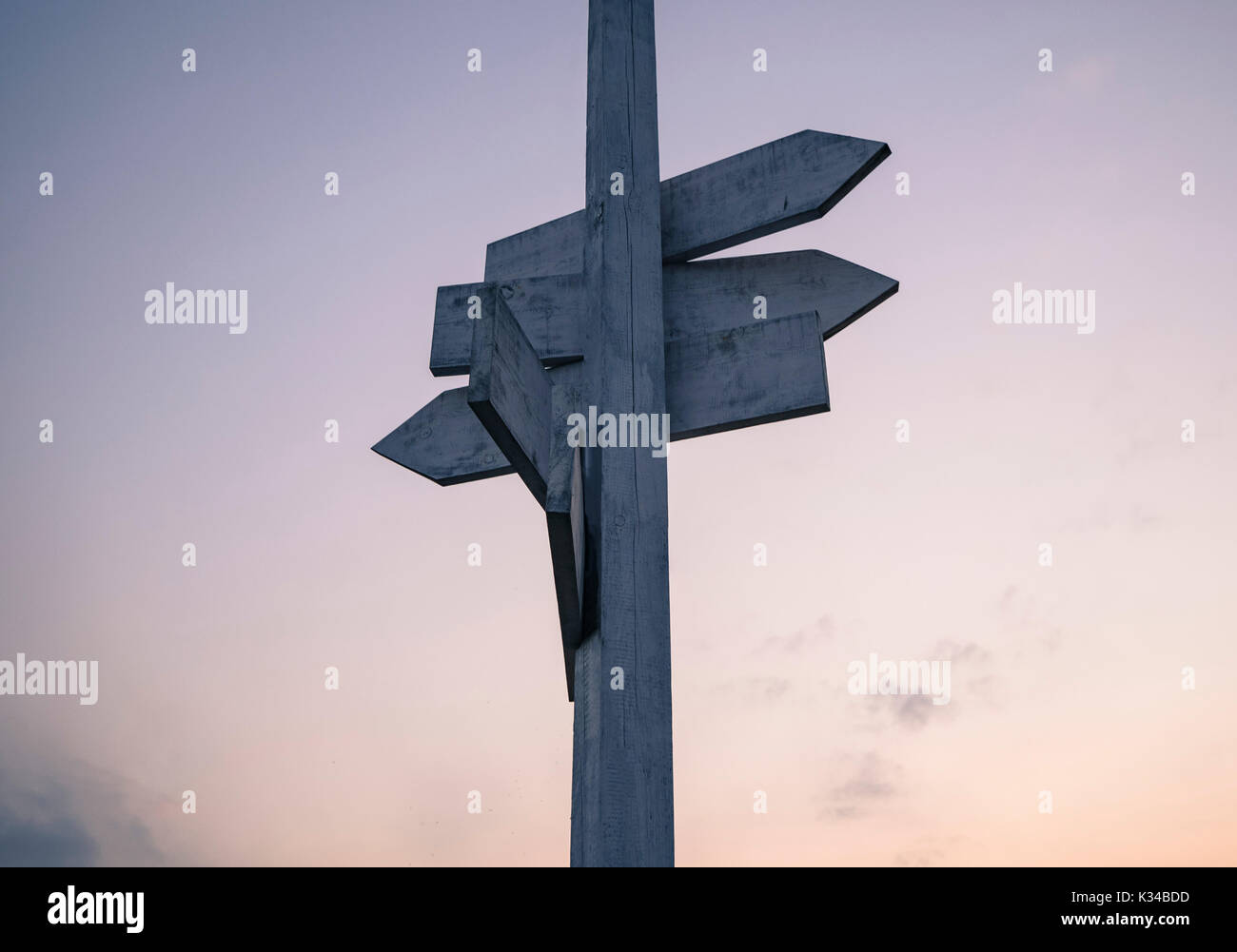 White wooden signpost with a sky during sunset in the background Stock ...