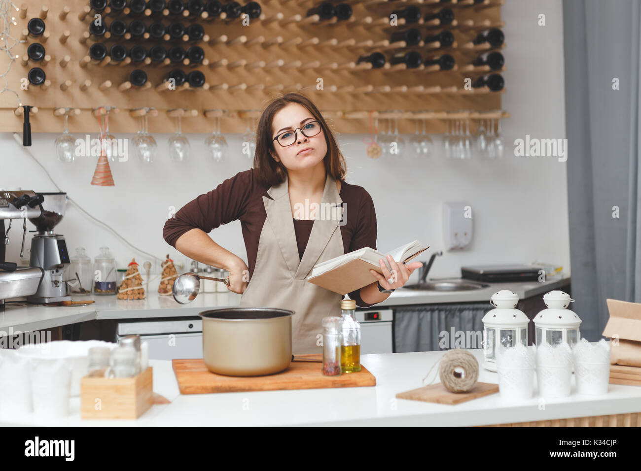 Young woman cooking soup in the kitchen Stock Photo - Alamy
