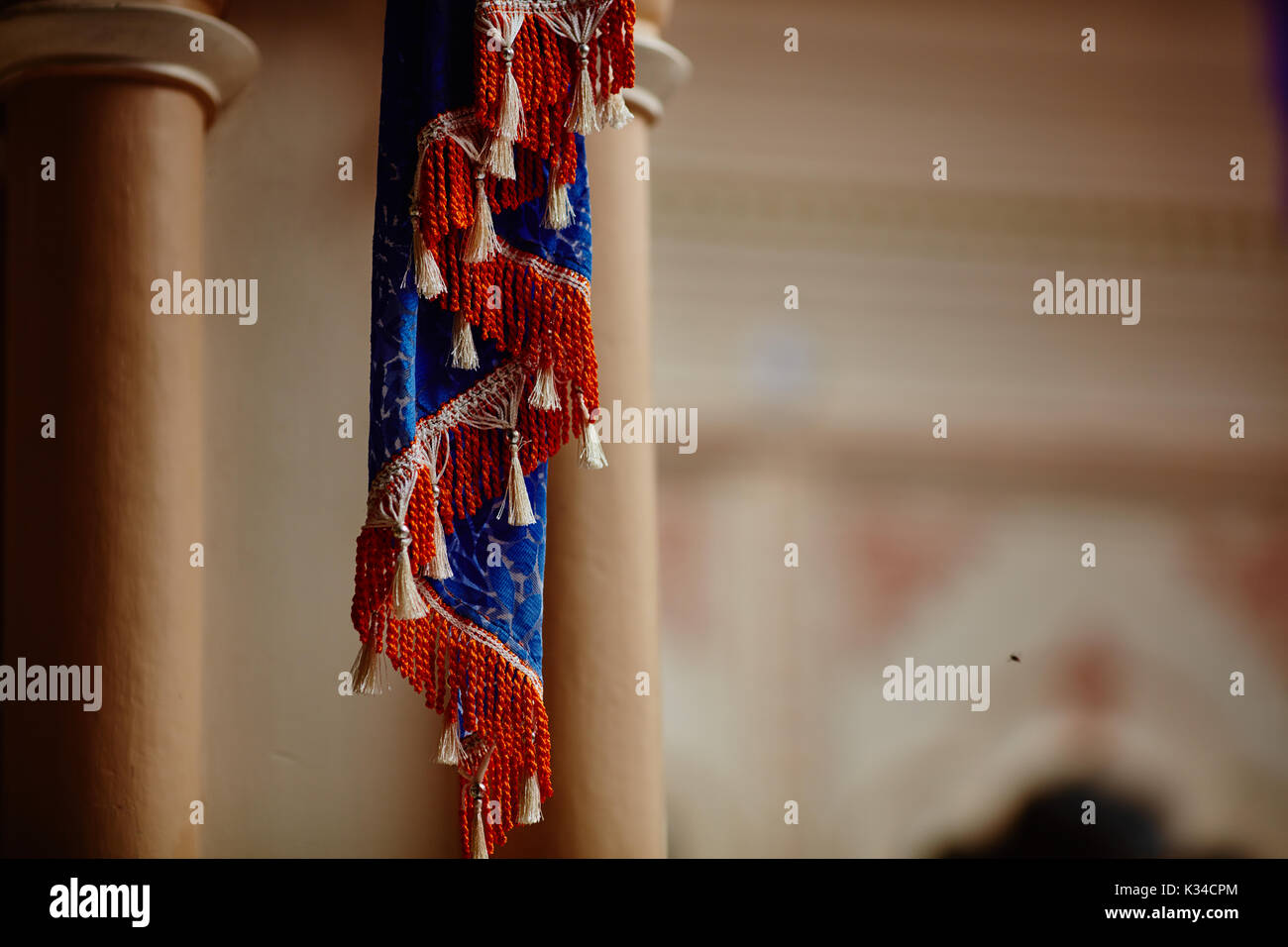 Textile decorations hanging inside Indian temple macro Stock Photo - Alamy