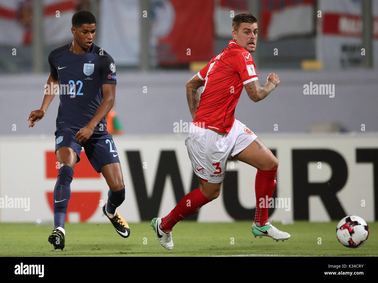 England's Marcus Rashford (left) and Malta's Sam Magri battle for the ...