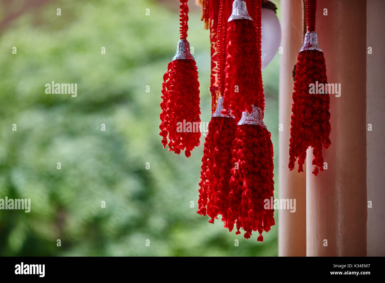 Textile decorations hanging inside Indian temple macro Stock Photo - Alamy