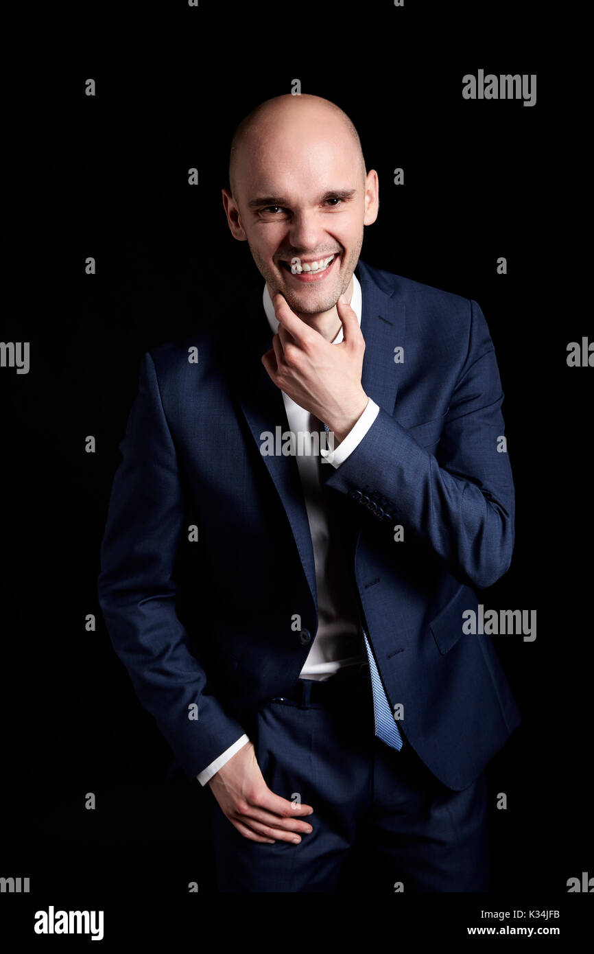 Portrait of crazy laughing man on black background Stock Photo - Alamy