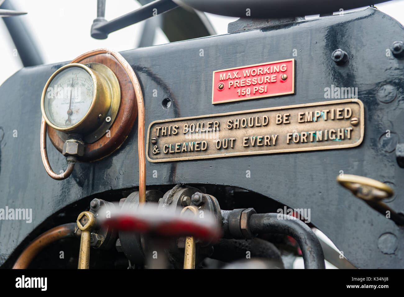 Steam engine pressure gauge, pipes and warning sign Stock Photo - Alamy