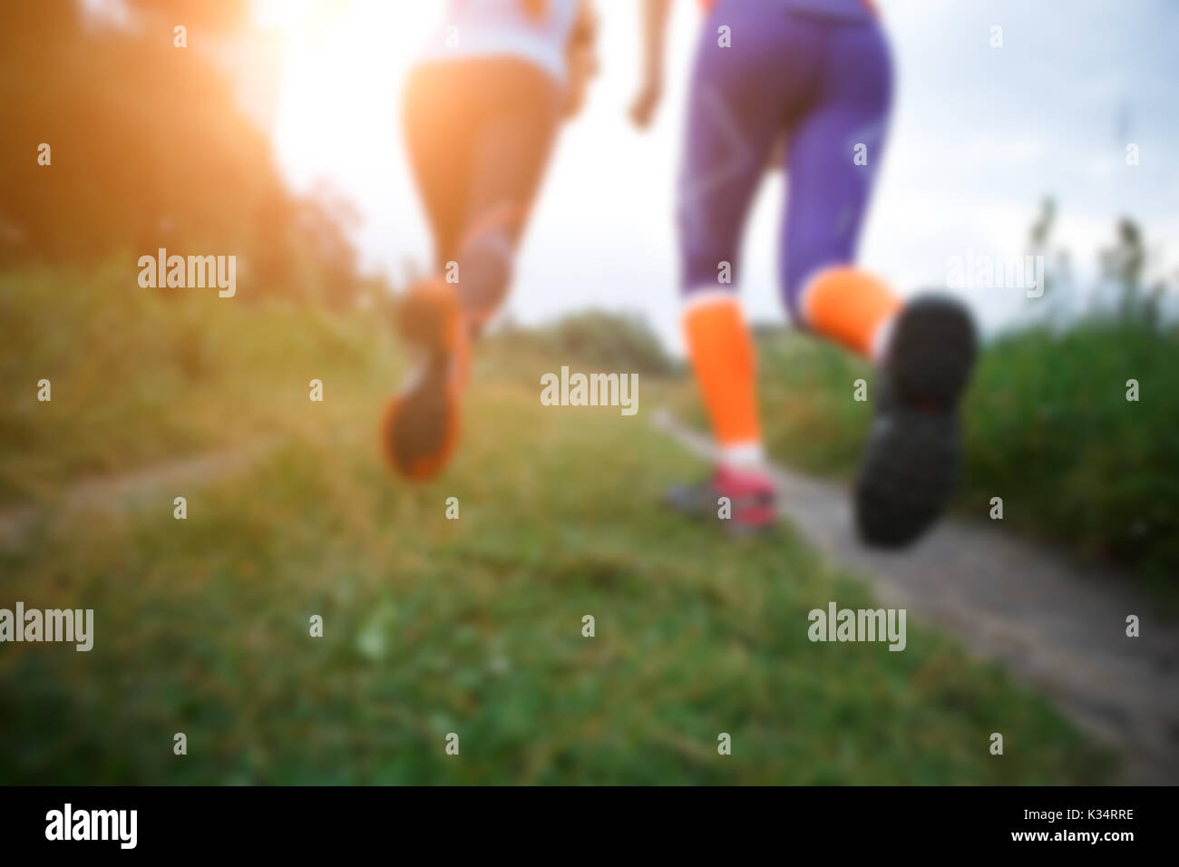 Two women running along road hi-res stock photography and images - Alamy