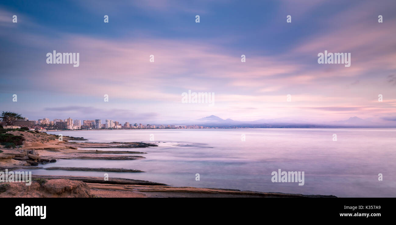 A view along the rocky shore at Cabo de Huertas, Alicante, Spain with ...