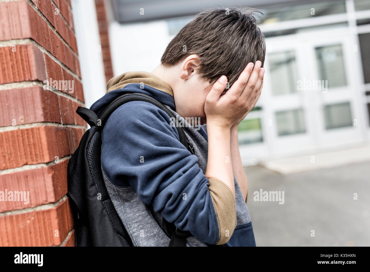 A Unhappy depress Pre teen boy at school Stock Photo - Alamy