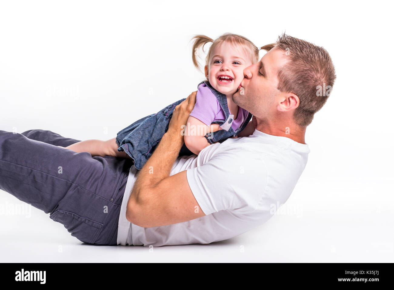 A Father and daughter lay on ground having fun Stock Photo - Alamy