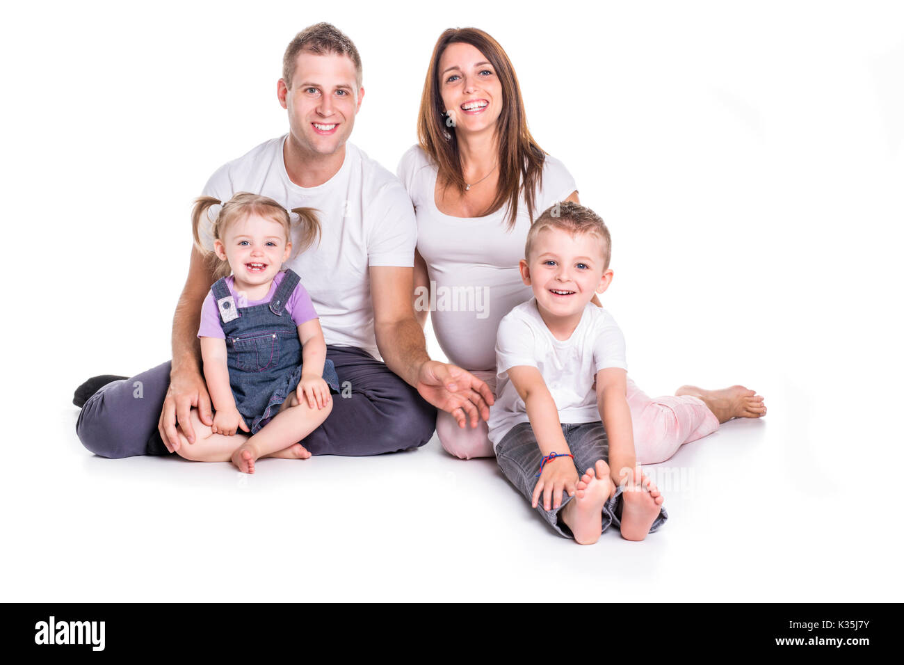 A Happy family with two kids on studio white Stock Photo - Alamy