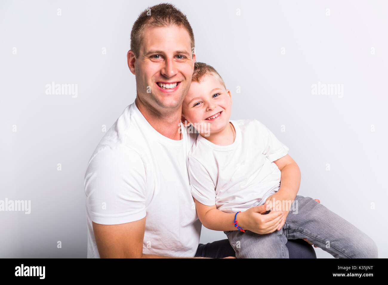 A Dad with son in the studio white background Stock Photo - Alamy