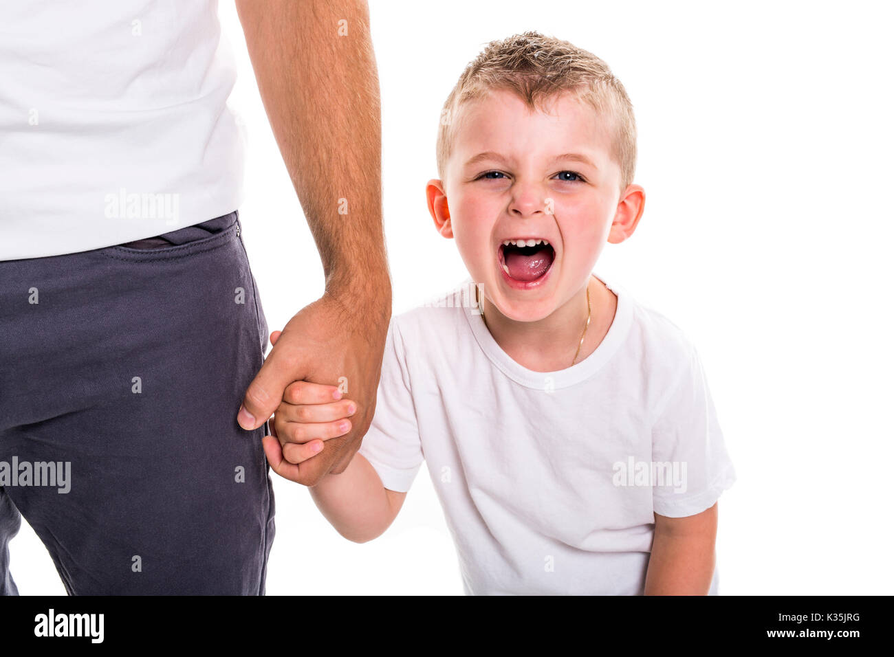 A Boy holding hands of his father standing against white background ...