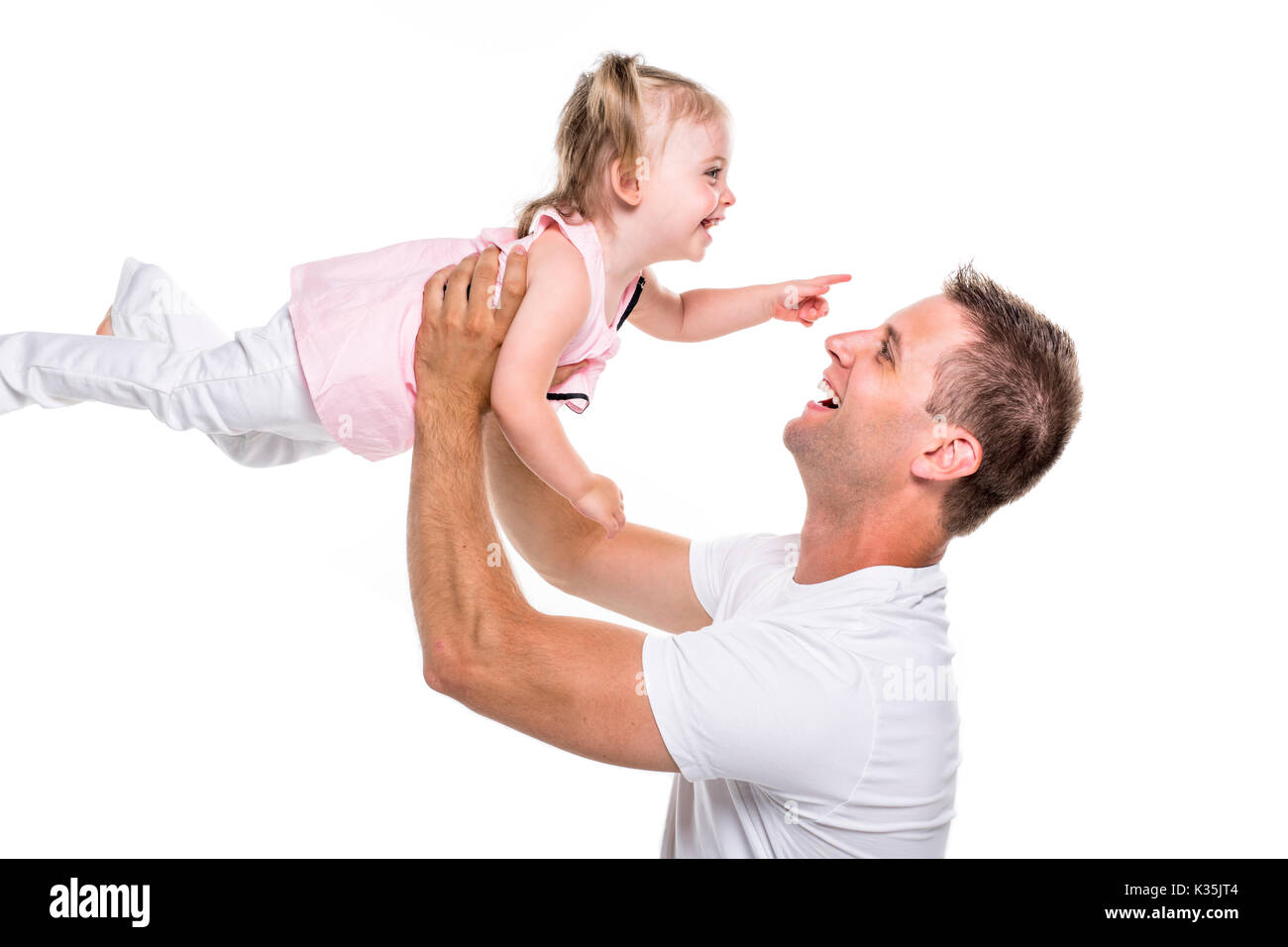 A portrait of father holding his adorable child on white background ...