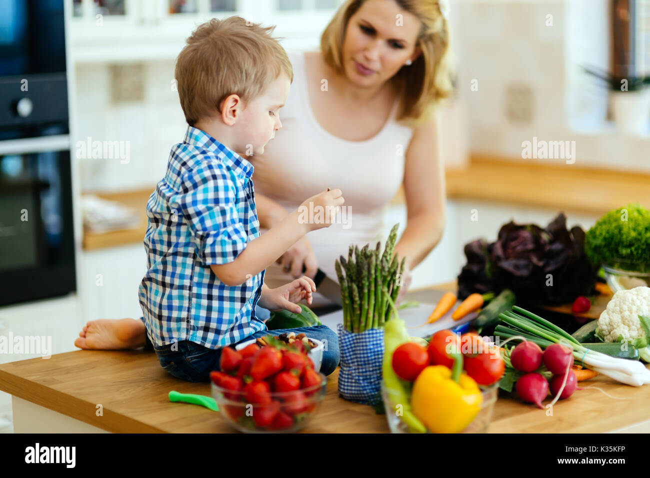 Mother and child preparing lunch Stock Photo - Alamy