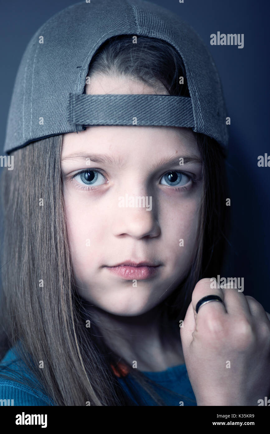 serious child girl portrait showing fist, ready to action Stock Photo ...