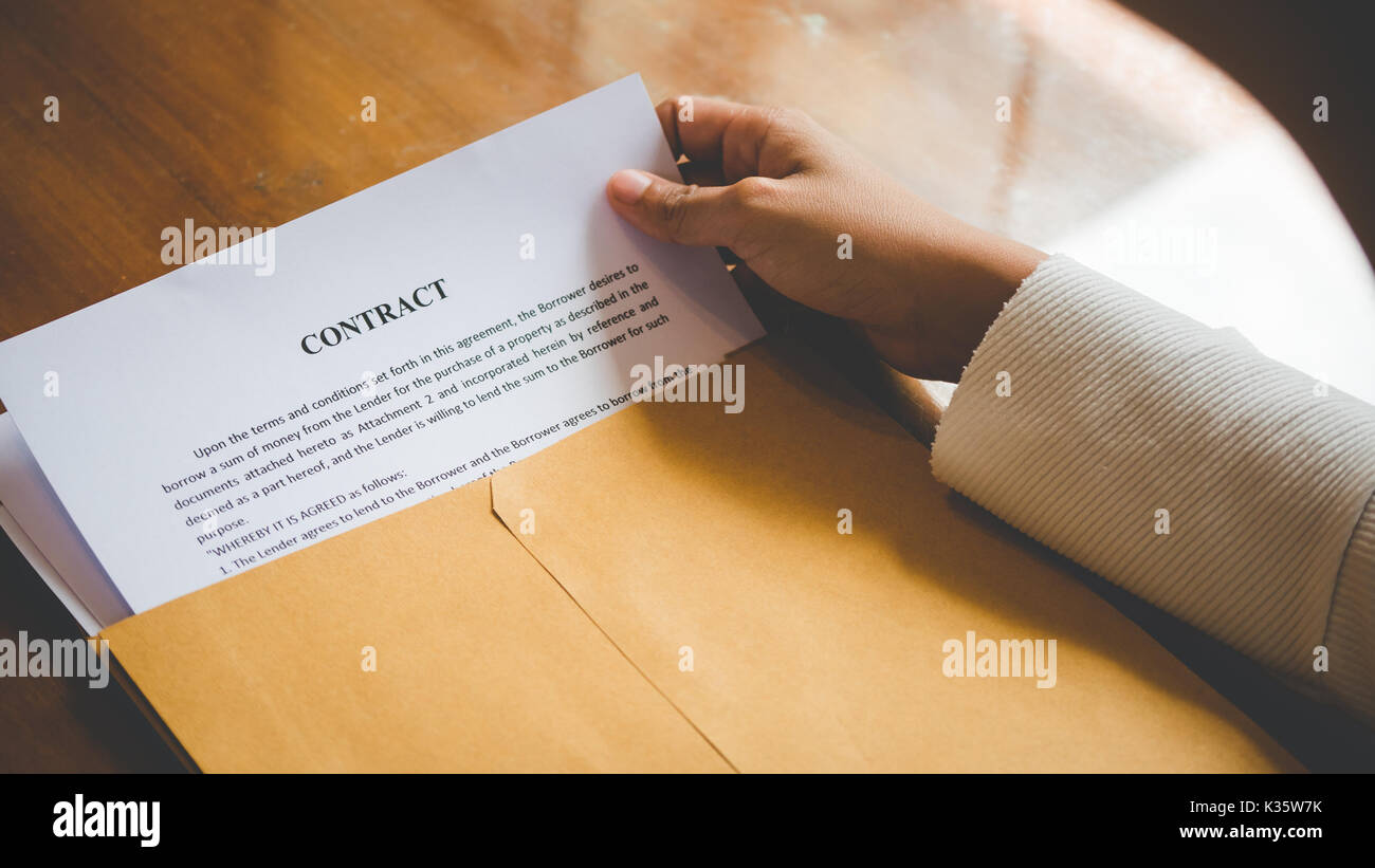 Women are opening an envelope document about signing a contract in ...