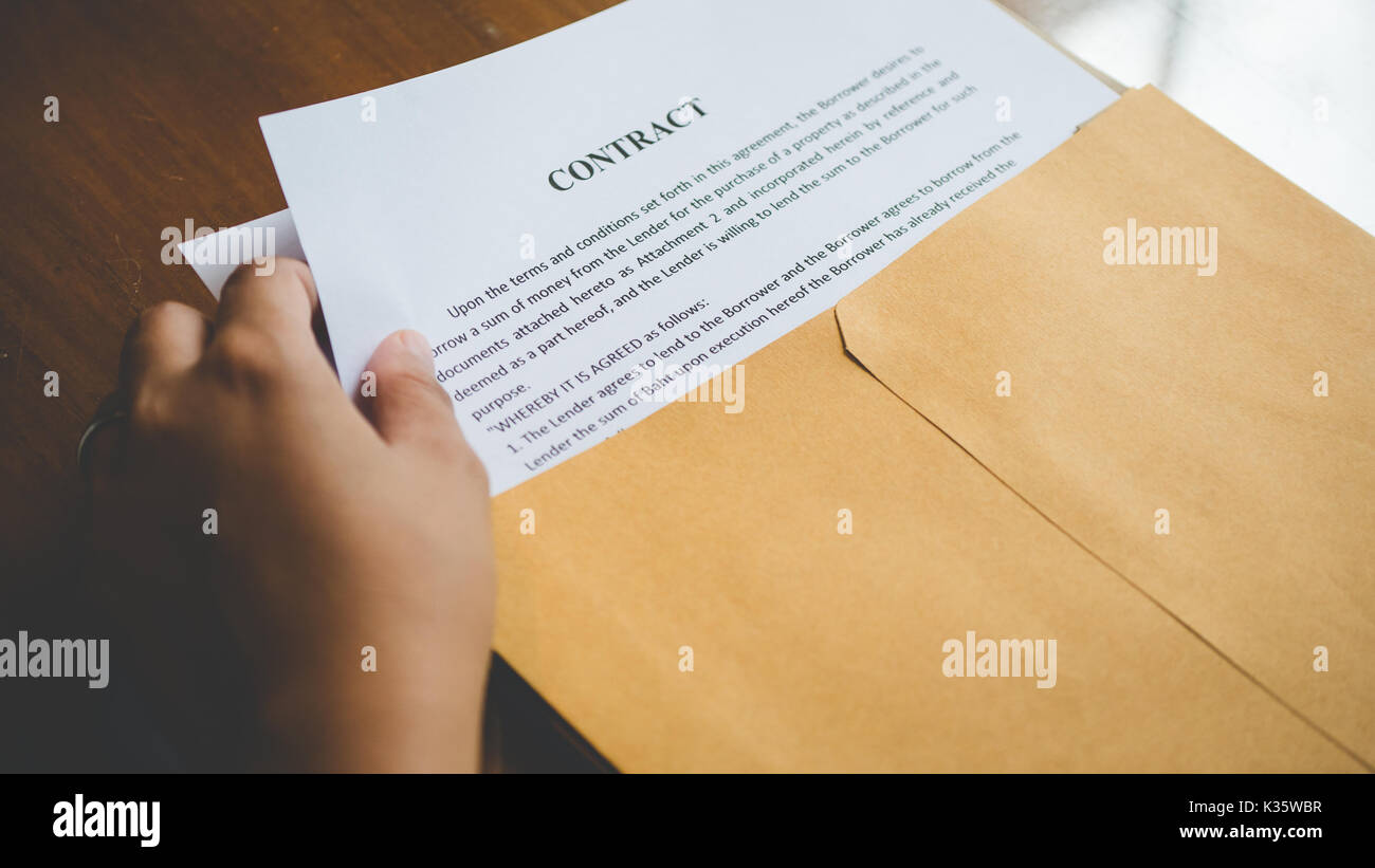 Women are opening an envelope document about signing a contract in ...