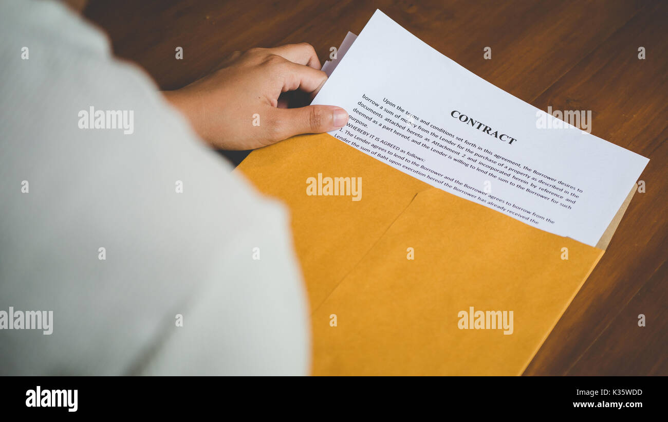 Women are opening an envelope document about signing a contract in ...