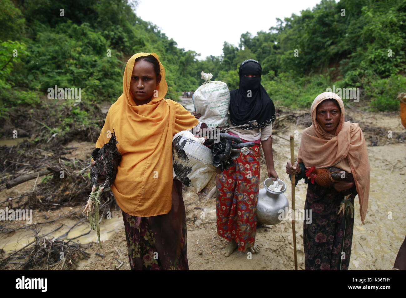 Ukhiya, Bangladesh. 1st Sep, 2017. Members of Myanmar's Muslim Rohingya minority walk through a ...