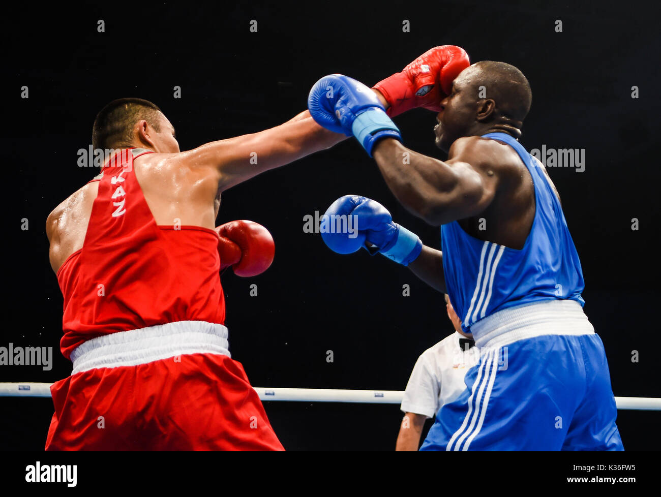Kazakh boxer Kamshybek Kunkabayev (L) fights Fokou Arsene from Cameroon ...
