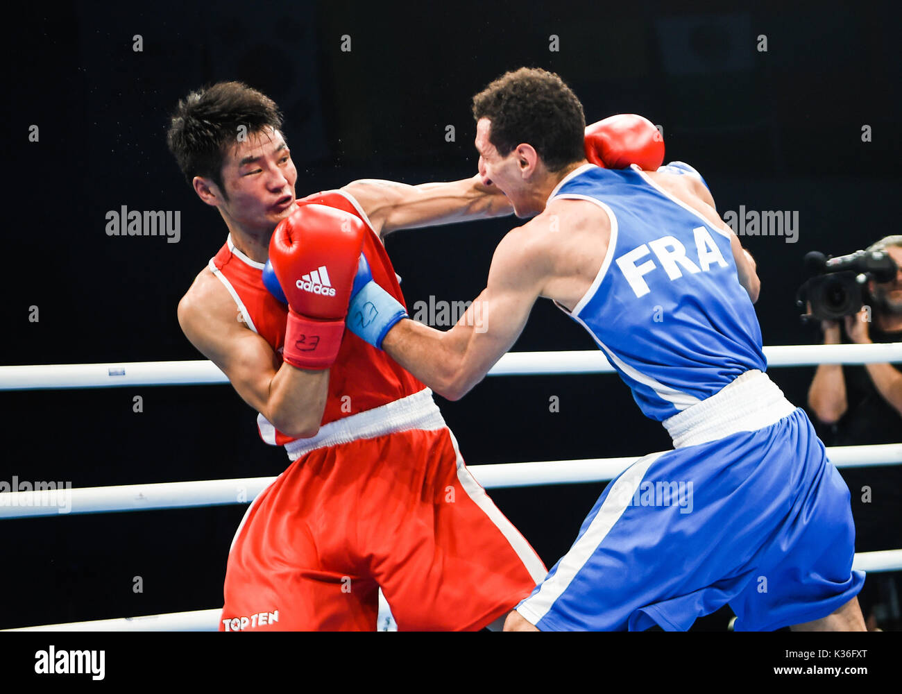 Mongolian boxer Otgondalai Dorjnyambuu (L) fights Sofiane Oumiha from ...