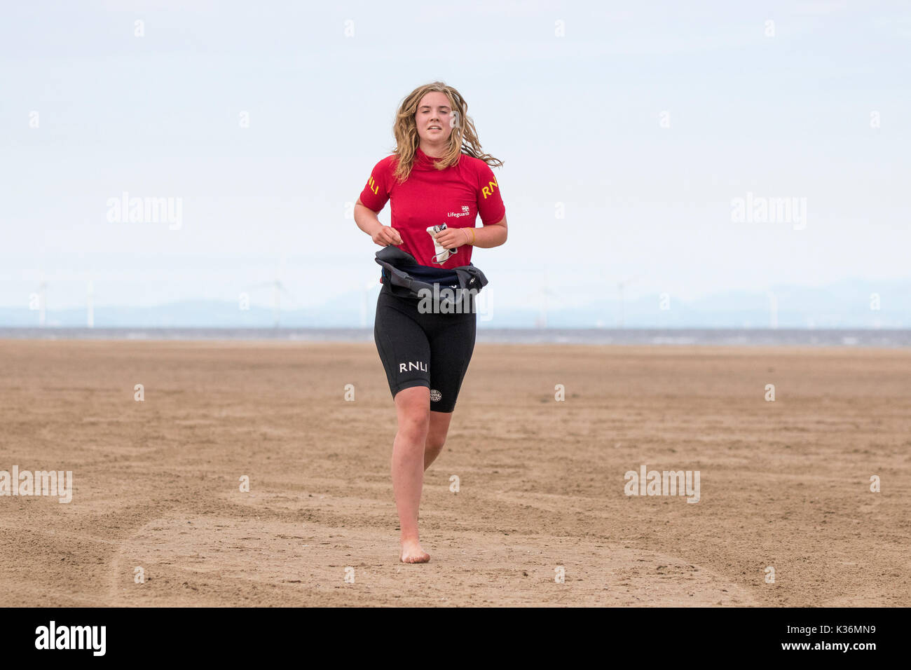 Running RNLI lifeguard sea save rescue rescuer emergency drown drowning ...