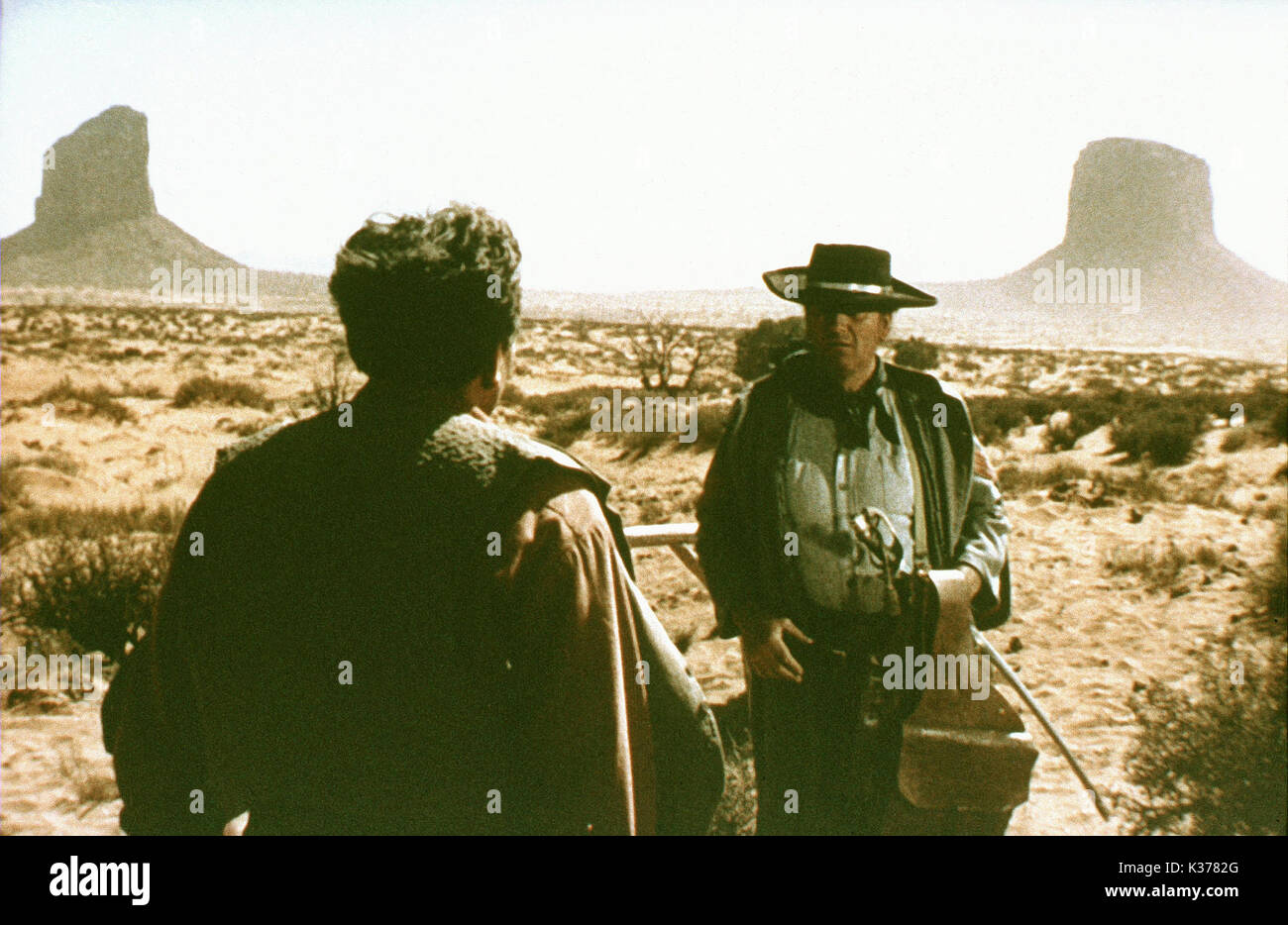 THE SEARCHERS WALTER COY, JOHN WAYNE as Ethan Edwards, returning from ...