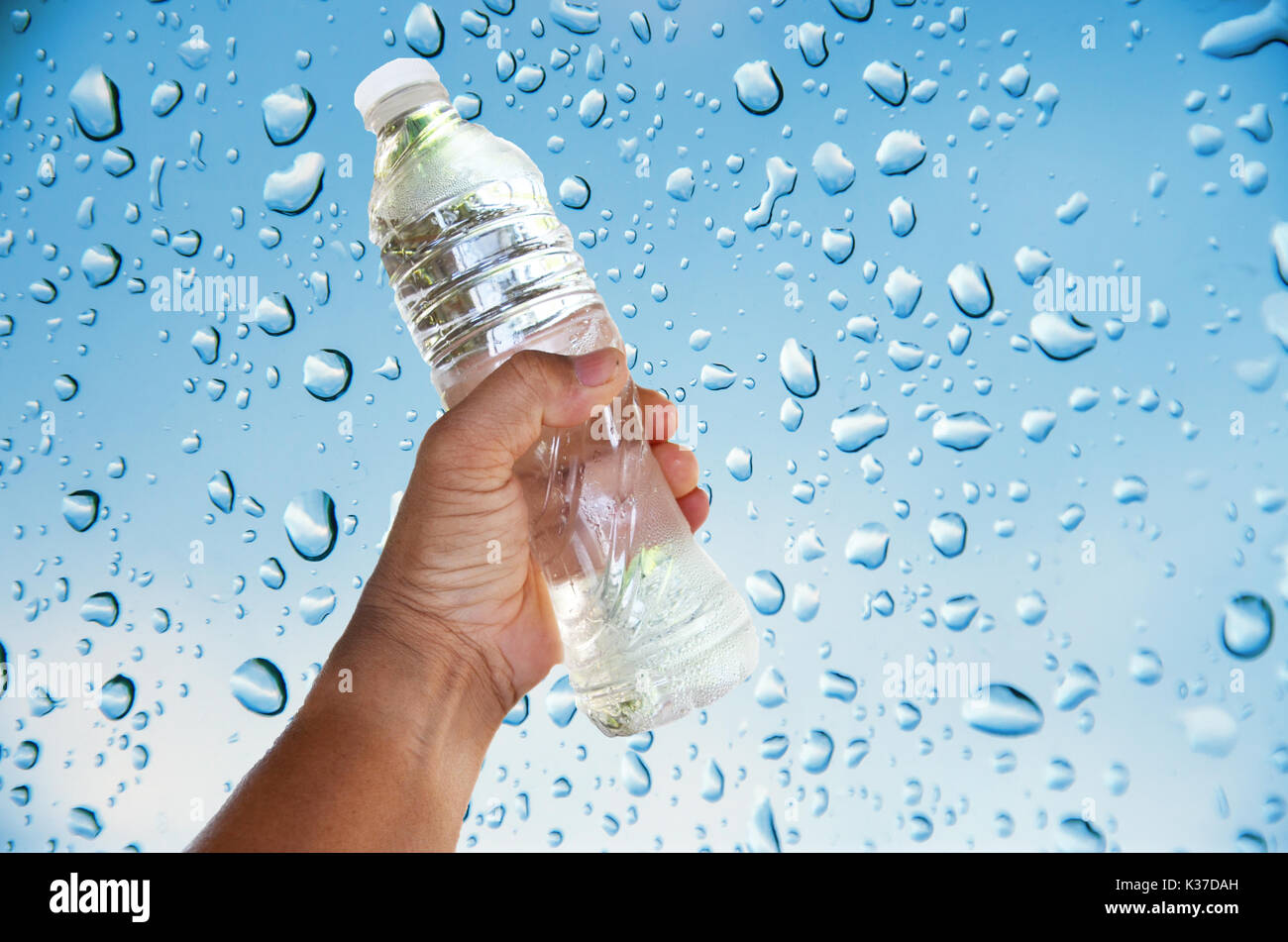 hand for bottle of water on drop water background Stock Photo - Alamy