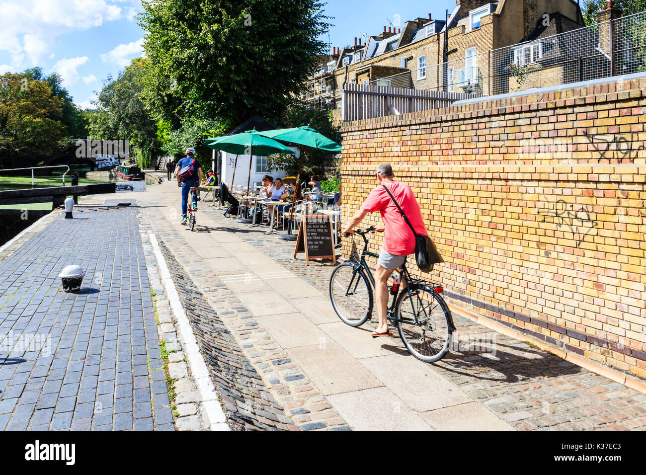 Two cyclists on the towpath of Regent's Canal, Islington, London, UK ...