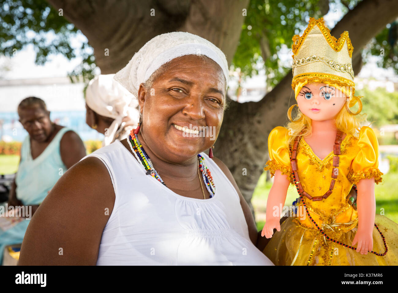 Santeria faith fortune teller with Santeria doll, Cuban woman following ...