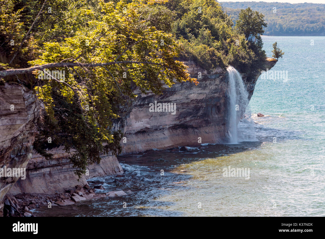 Spray Falls cascades over Pictured Rocks National Lakeshore and empties ...