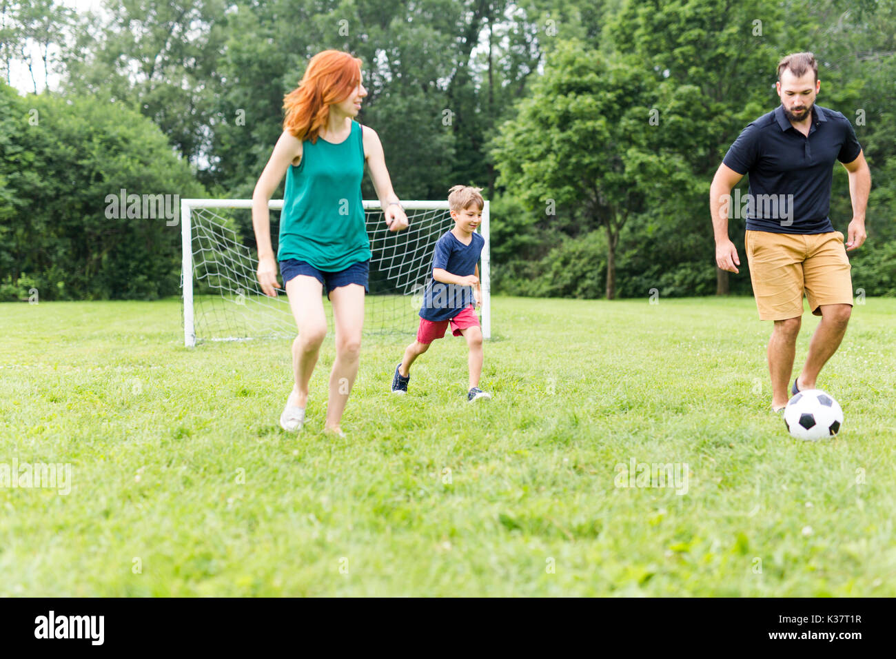 Cheerful mother son football hi-res stock photography and images - Alamy