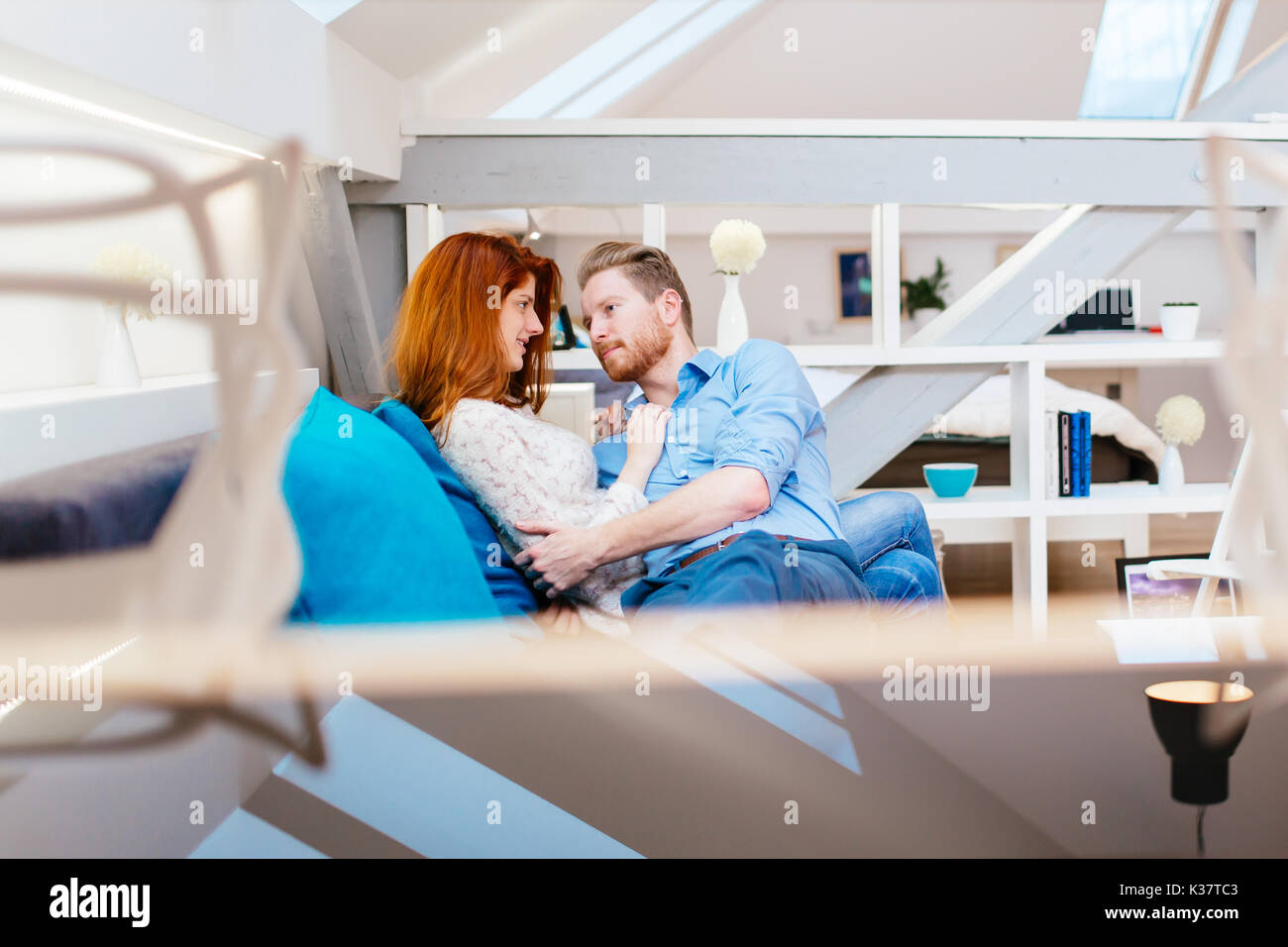 Couple cuddling in beautiful interior living room Stock Photo - Alamy