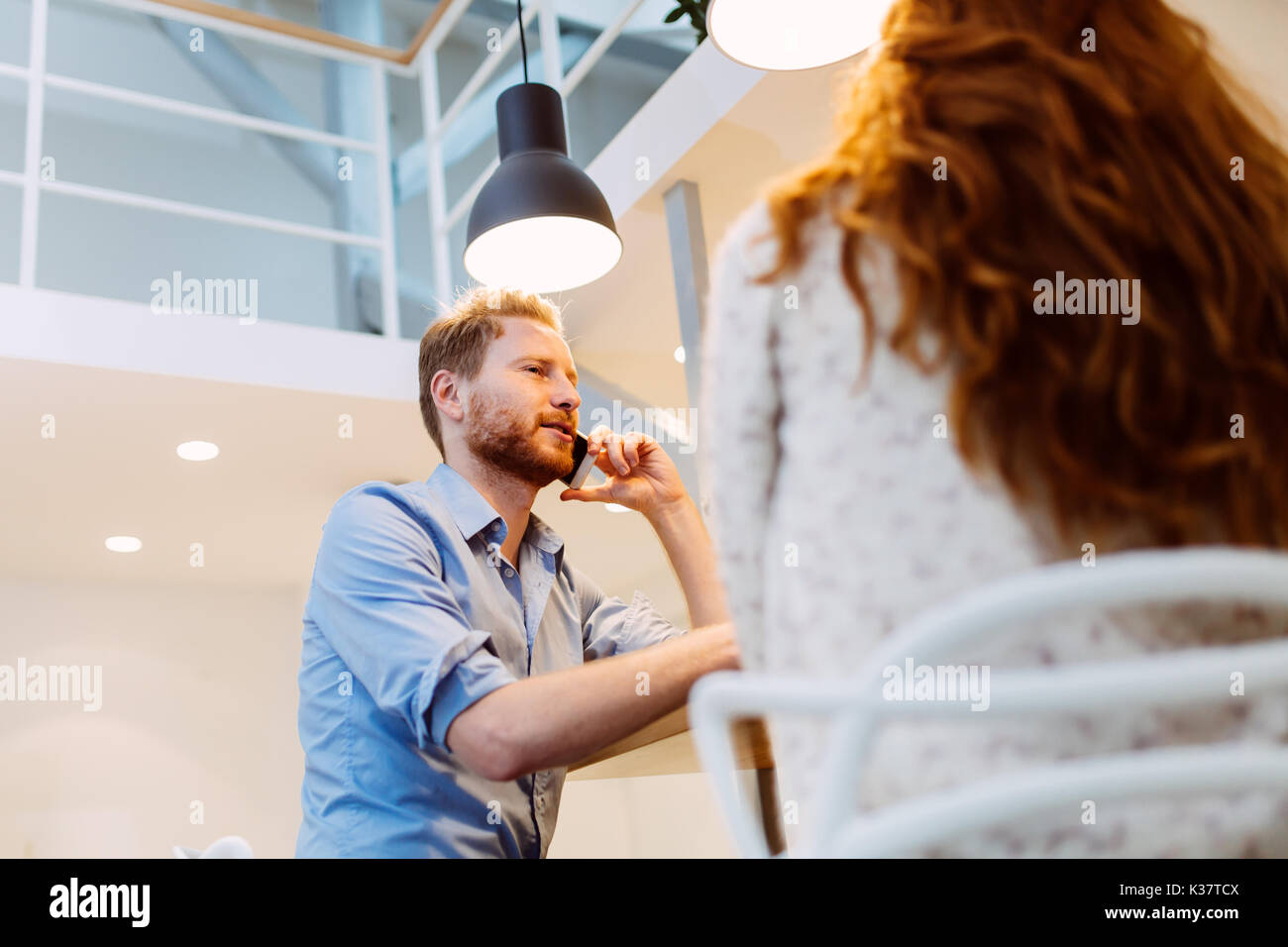 Talking on phone while dating woman Stock Photo - Alamy