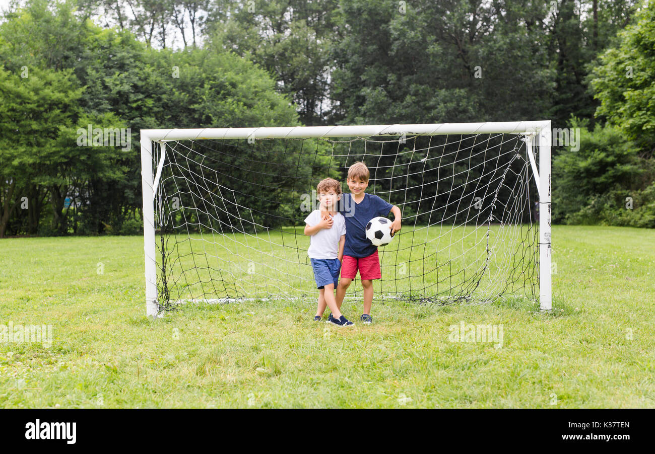 Two brothers having fun playing with ball Stock Photo - Alamy