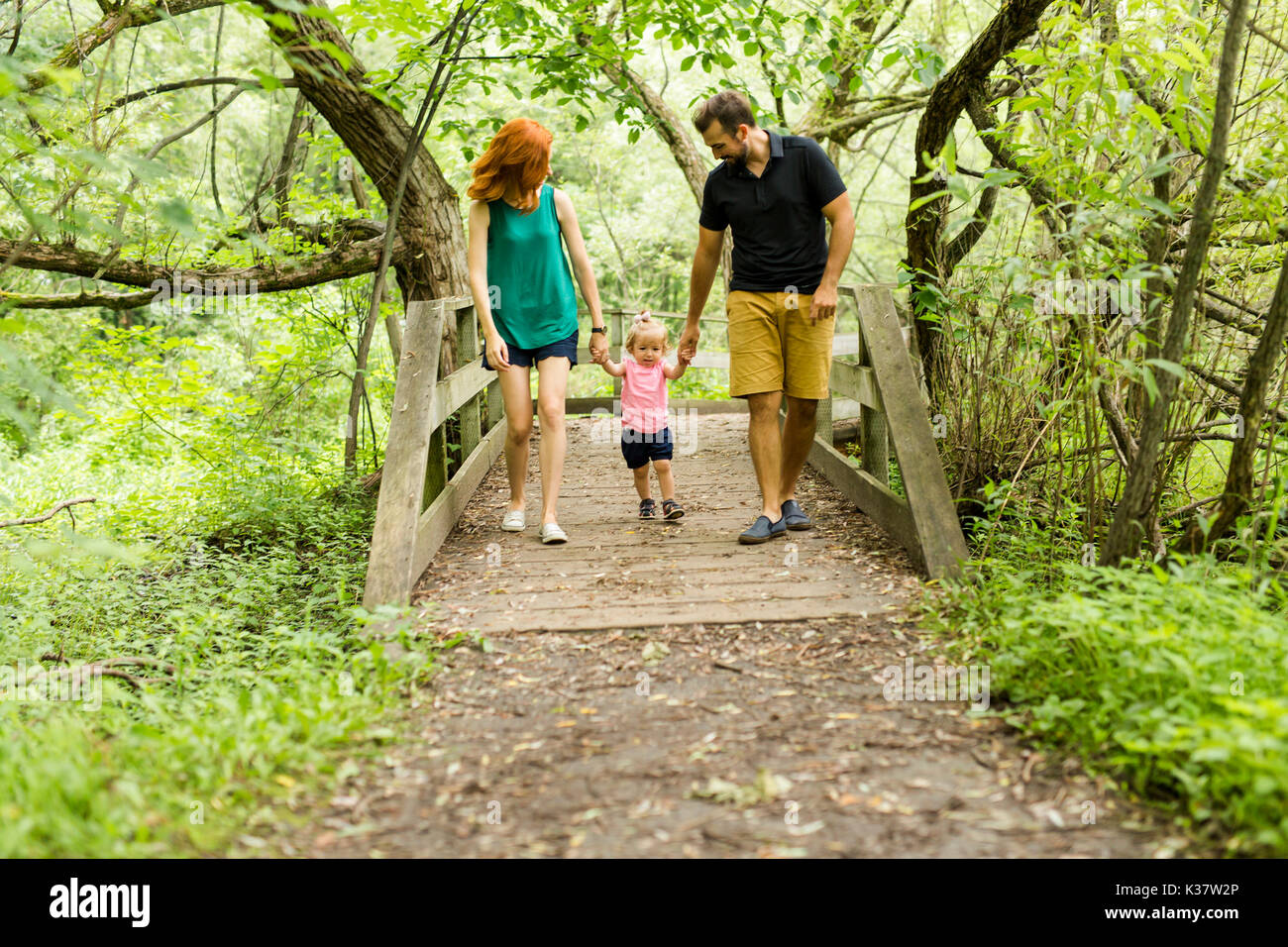 Mother, father and daughter on the promenade. First steps Stock Photo ...