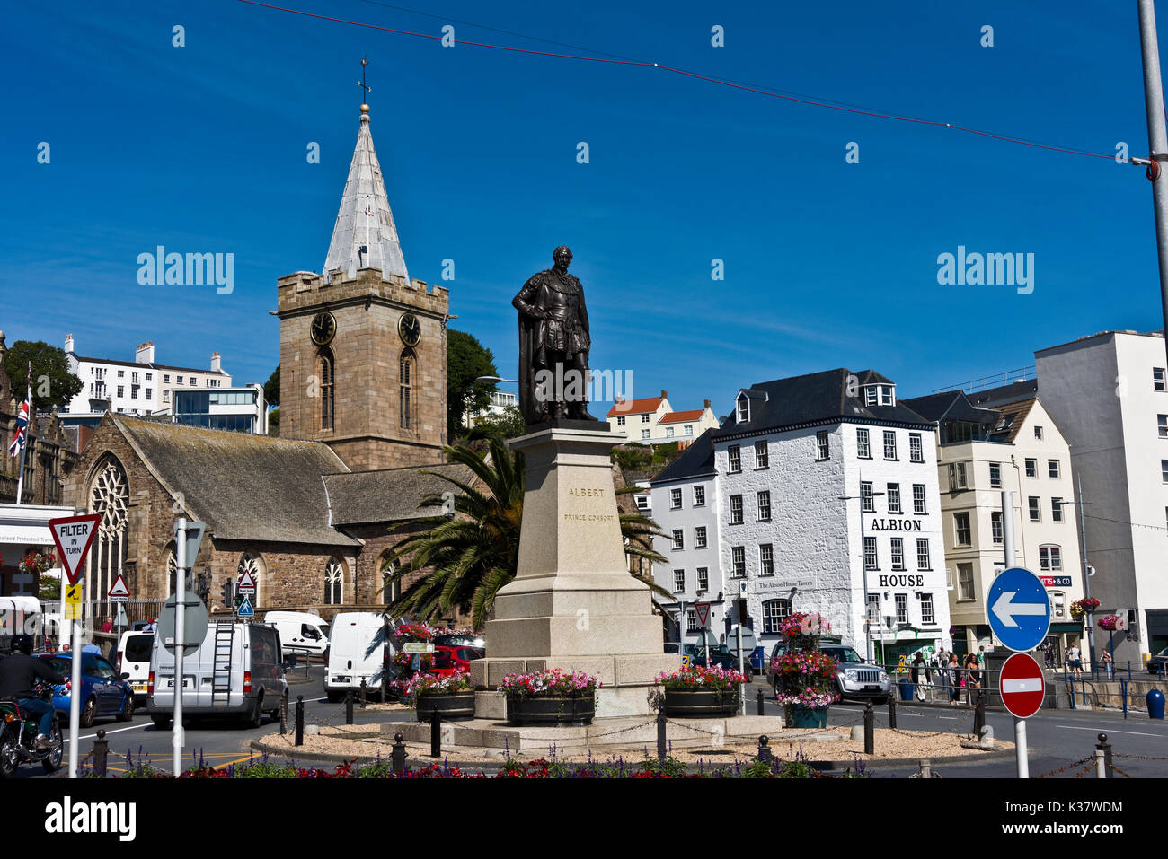 St Peter Port waterfront by marinas; roundabout with statue of Prince ...