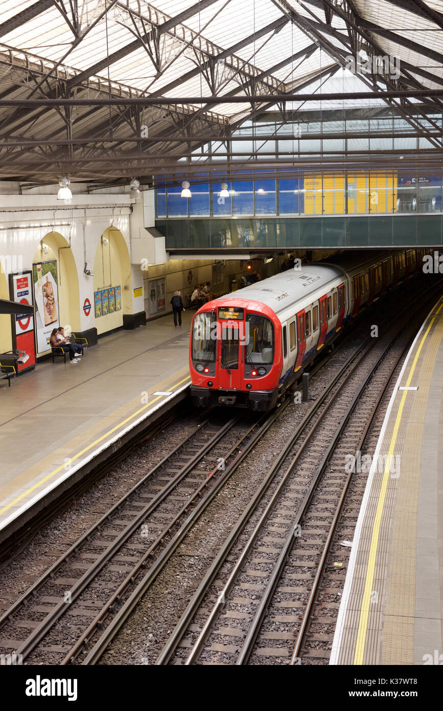 District Line train at Fulham Broadway Underground station in London ...