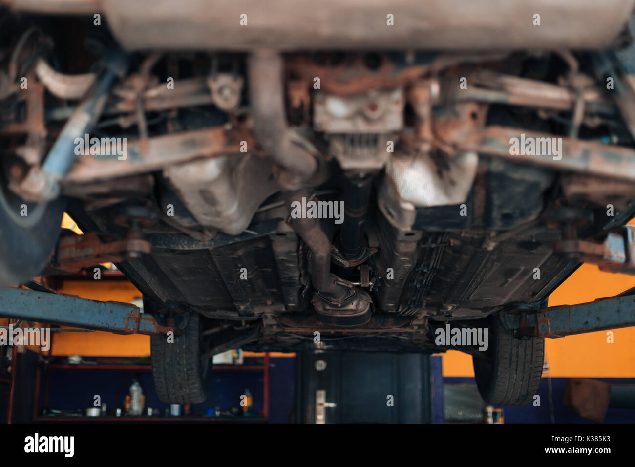 Auto view from the bottom. Garage mechanic raised the car on the lift ...