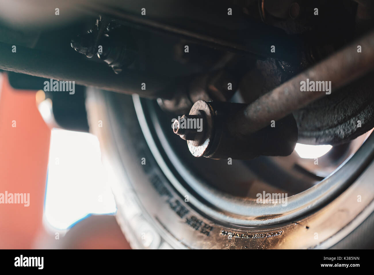 Car wheel bottom view. Garage mechanic raised the car on the lift Stock ...