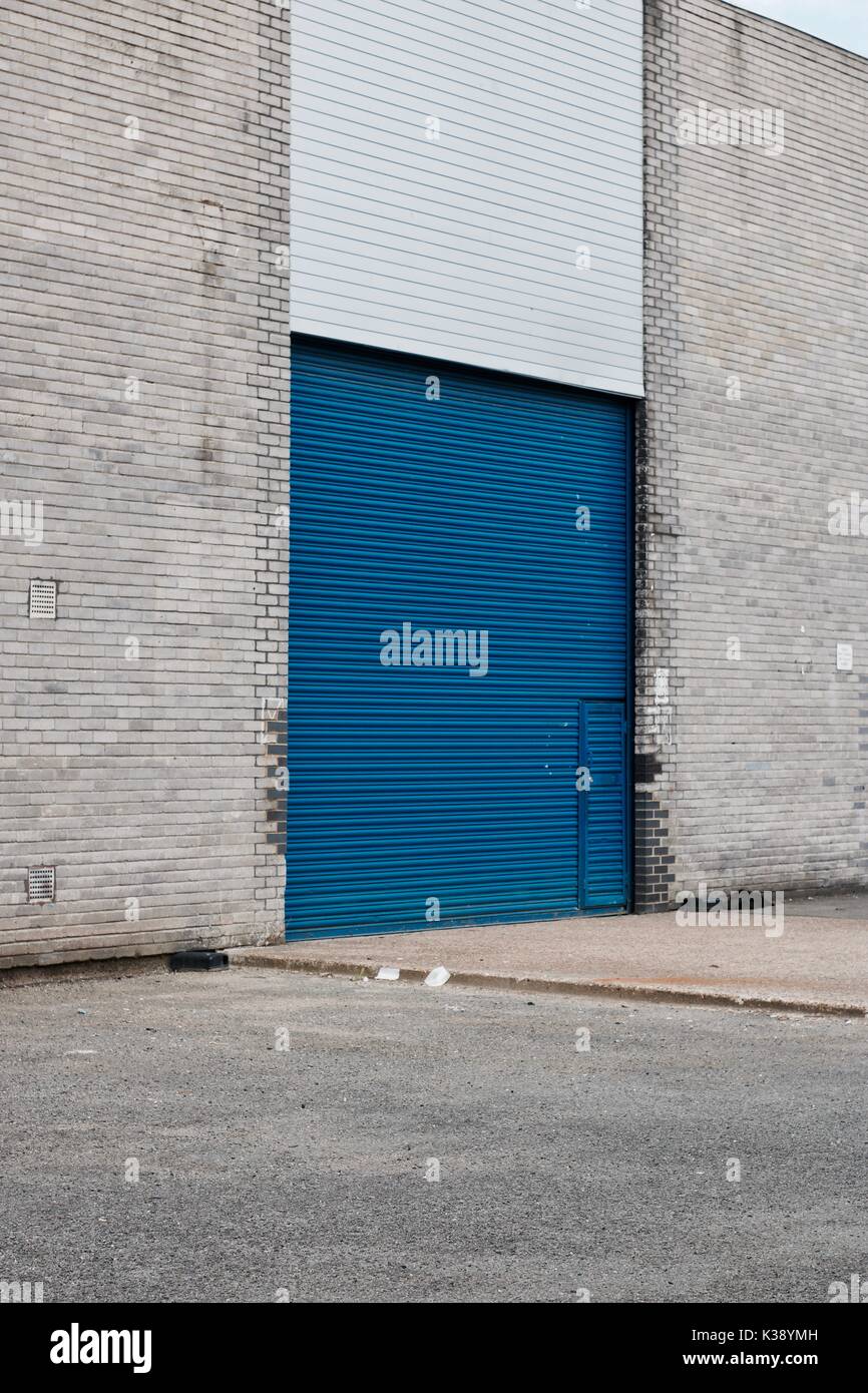 Big blue gateway with small doors in warehouse. London concept Stock ...