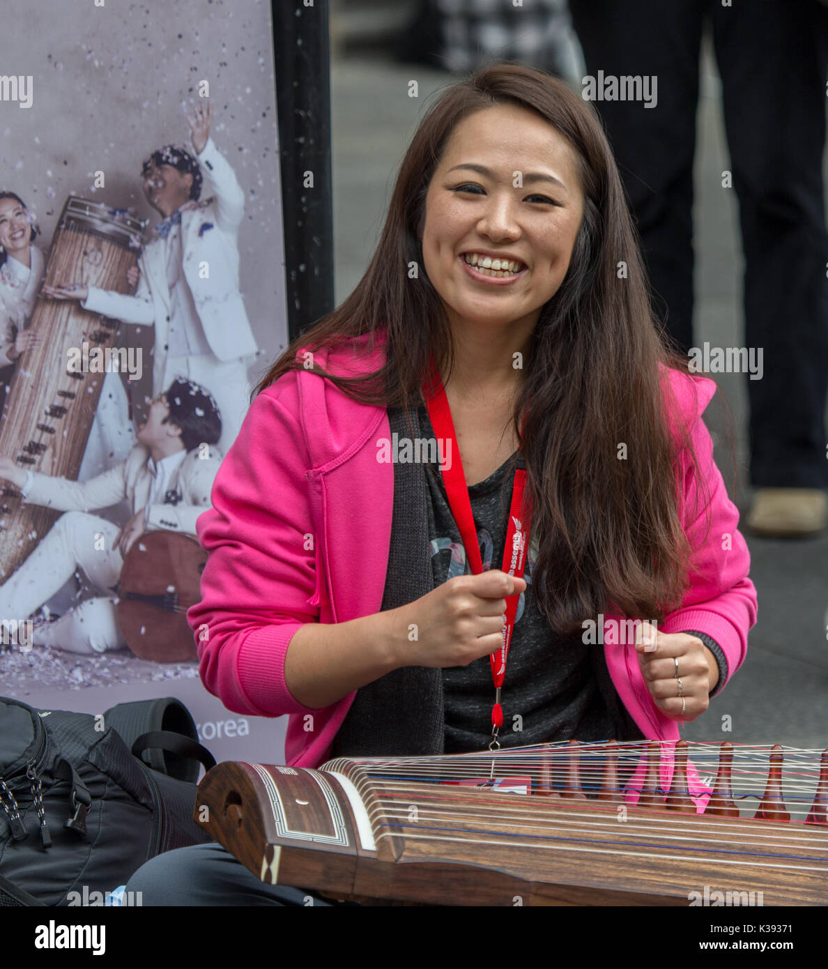 A young Korean musician playing a traditional stringed instrument at ...
