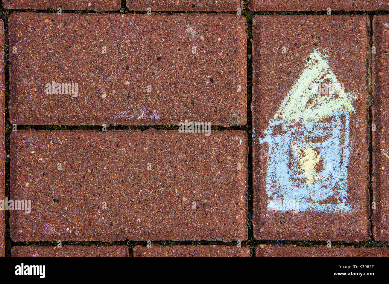 Childish chalk drawing of a house on a brick pavement Stock Photo - Alamy