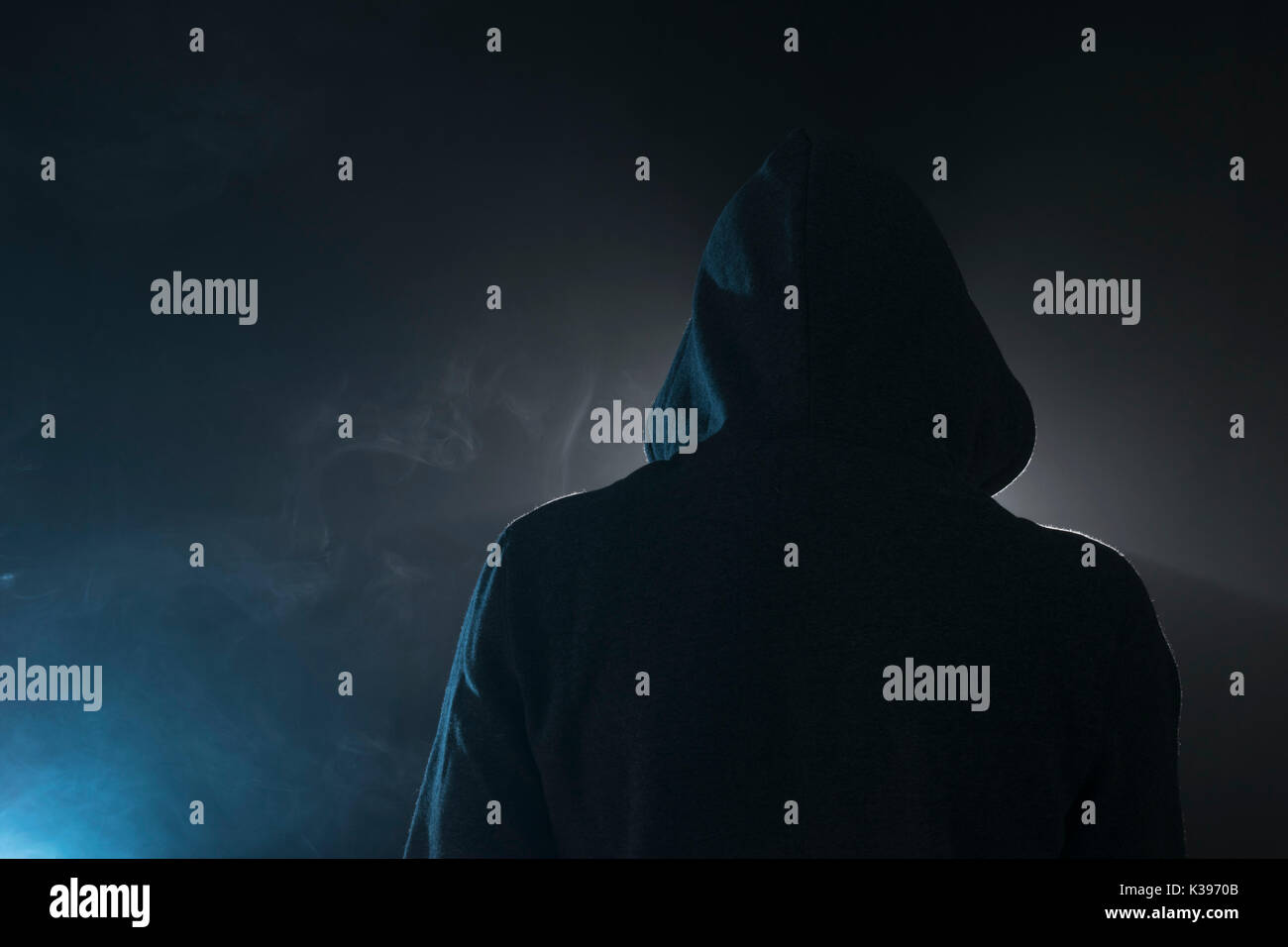 Isolated young man standing in a dark mysterious place Stock Photo - Alamy
