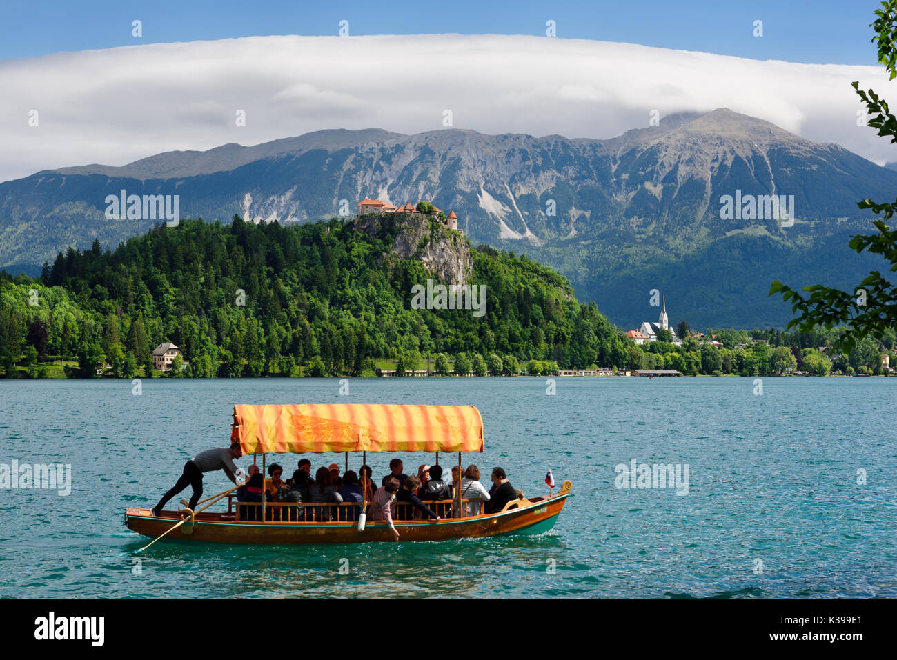 Traditional Pletna boat with colorful canopy on Lake Bled with Bled ...